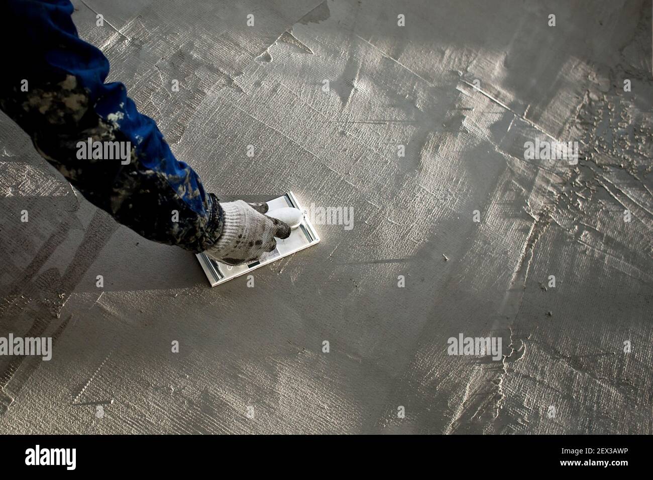 Working with a construction sander, preparing the walls for tiling. Wet ...