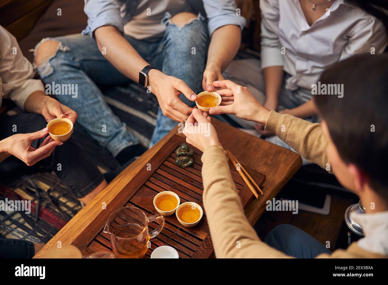 Young people having traditional tea ceremony in cafe Stock Photo - Alamy