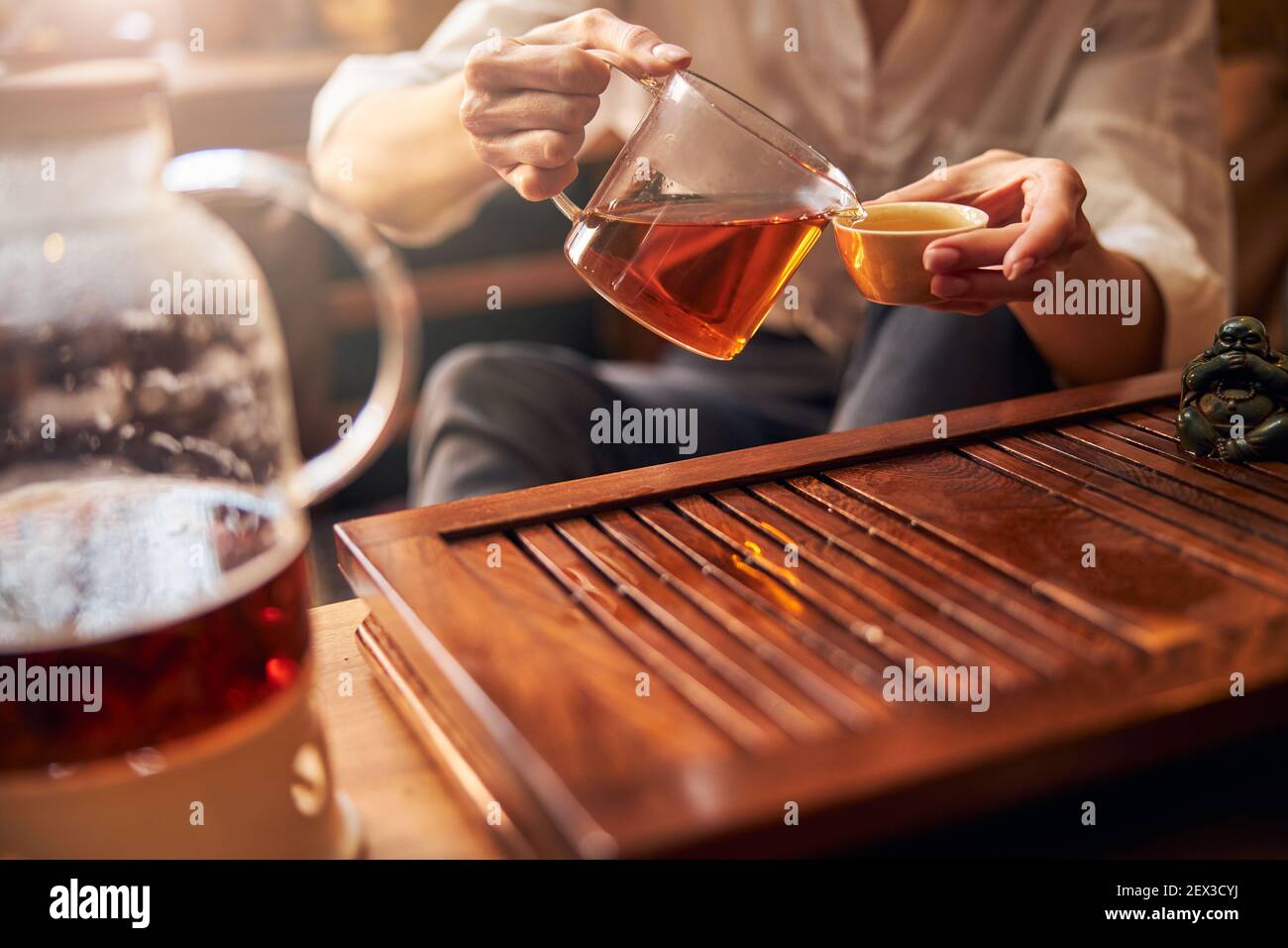 Young woman performing traditional tea ceremony in cafe Stock Photo - Alamy