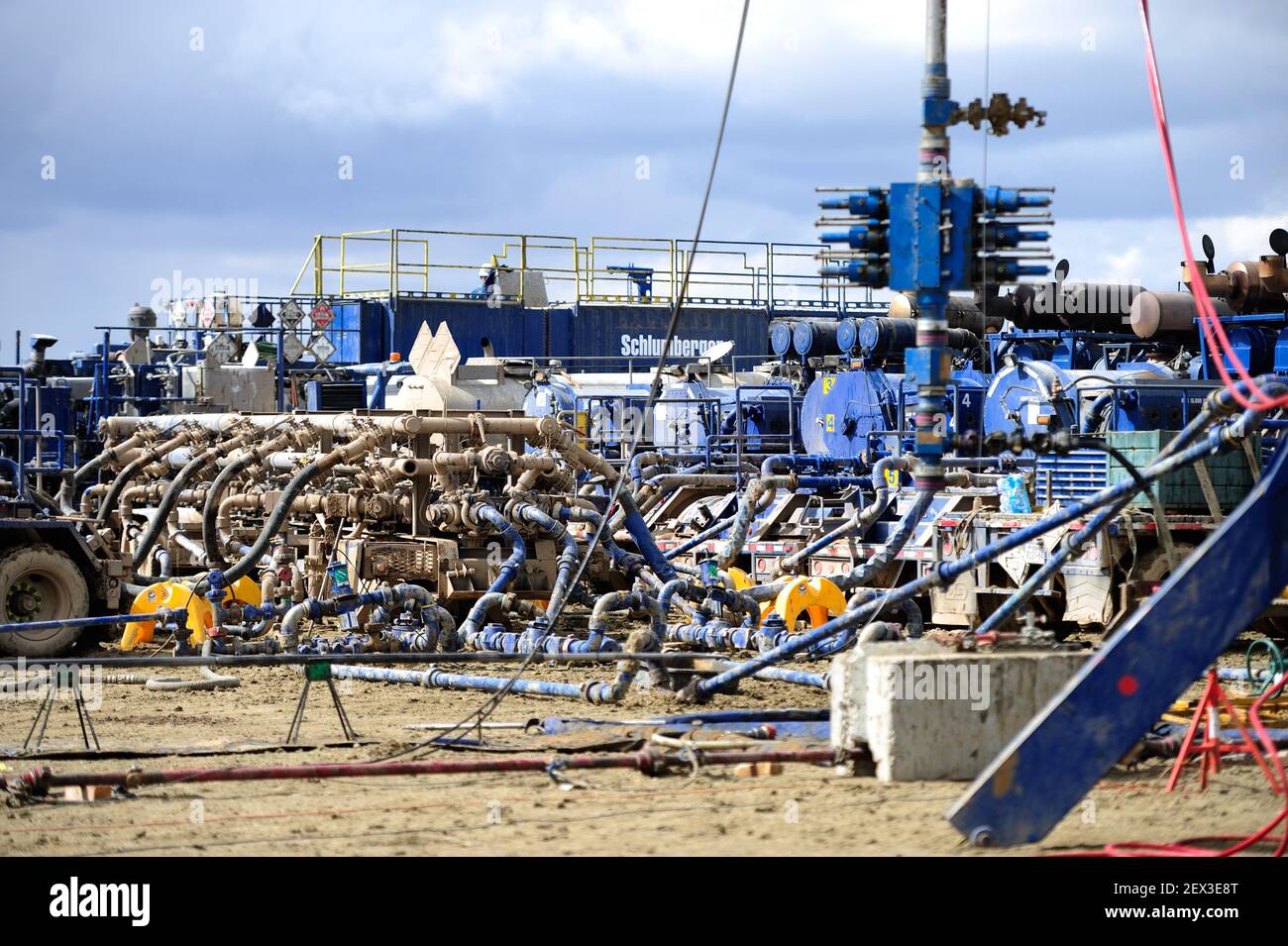 Schlumberger trucks with 2000 horsepower pumps direct water, sand and ...
