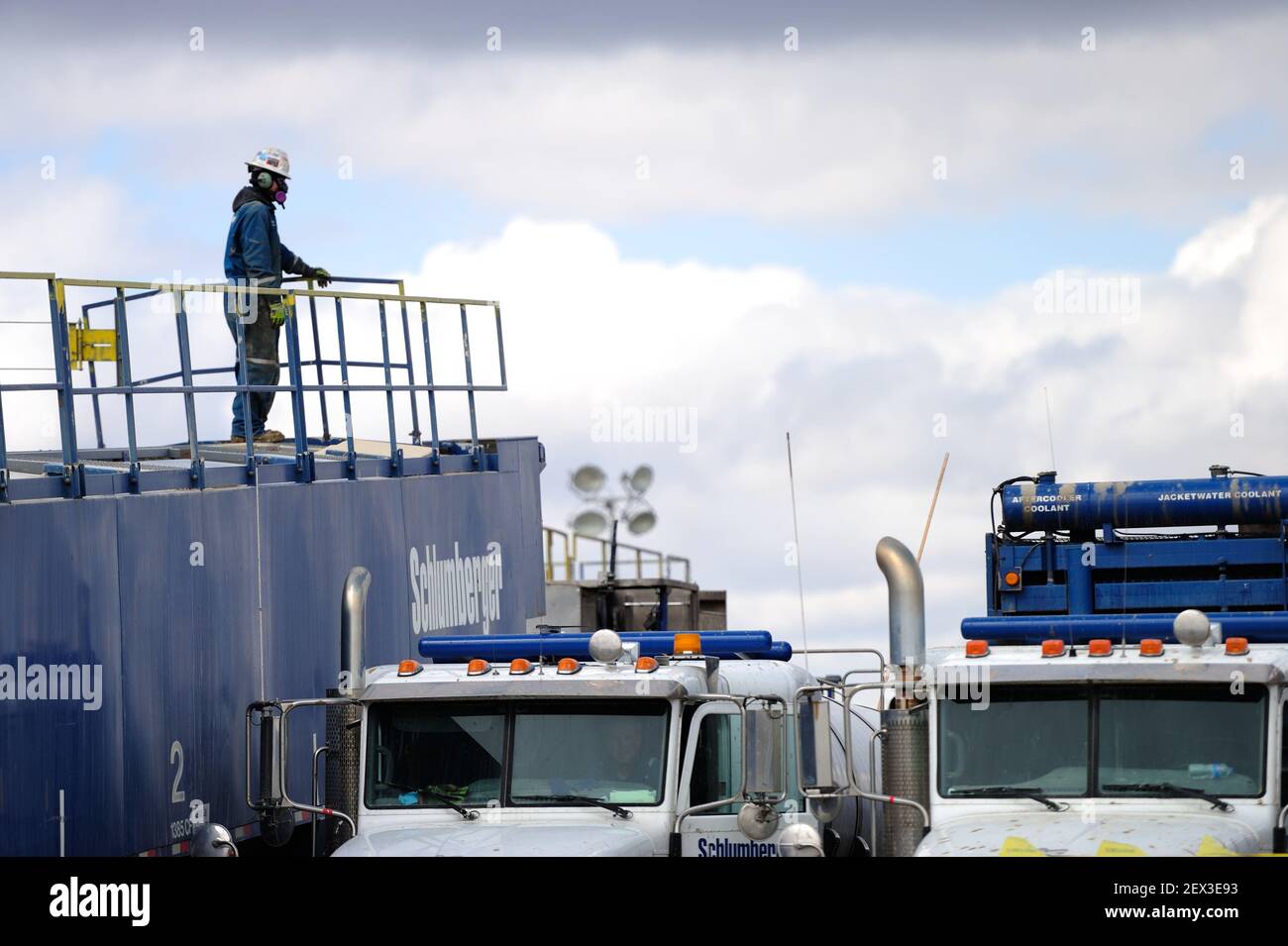 Schlumberger trucks with 2000 horsepower pumps direct water, sand and ...