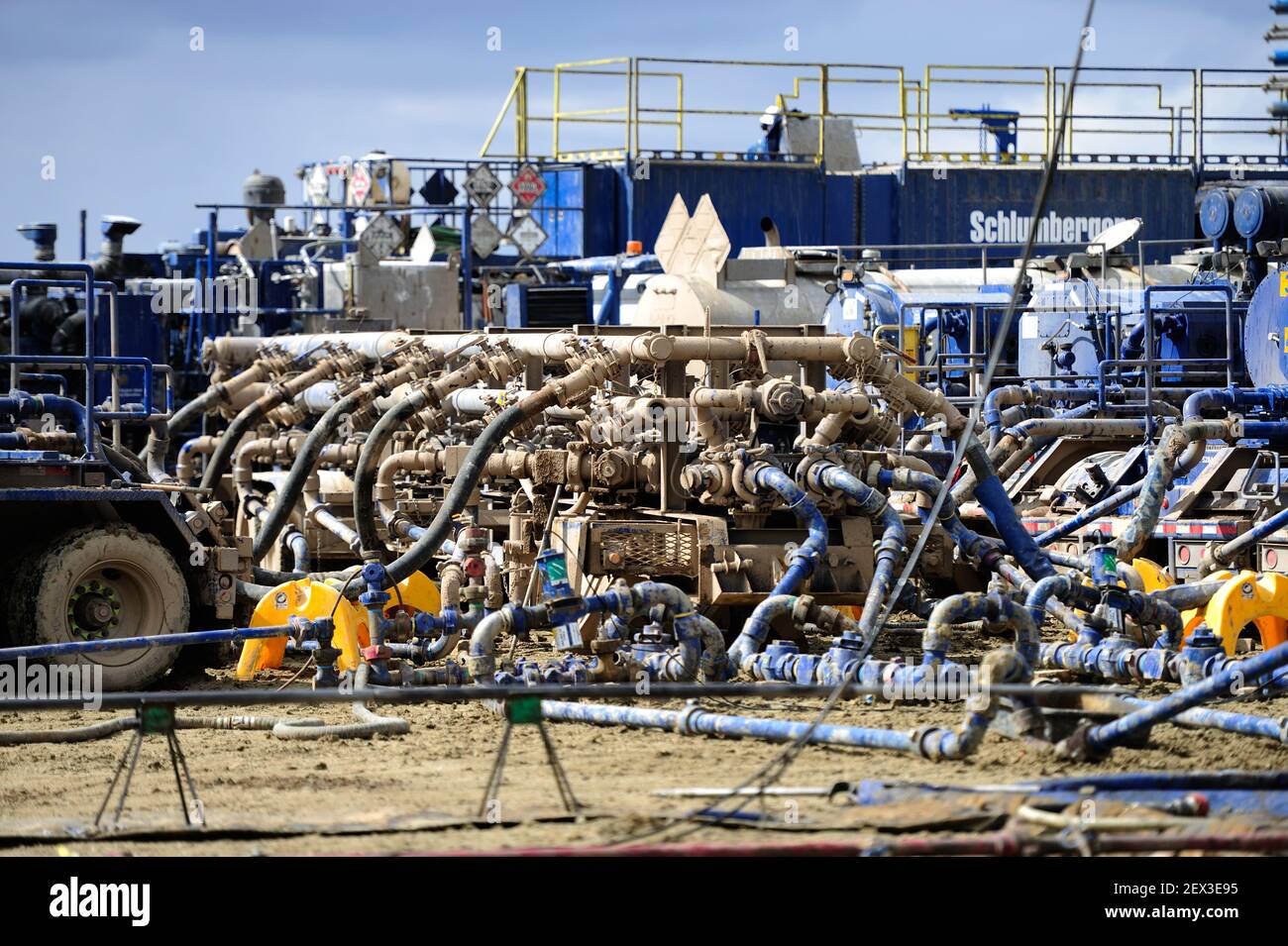 Schlumberger trucks with 2000 horsepower pumps direct water, sand and ...