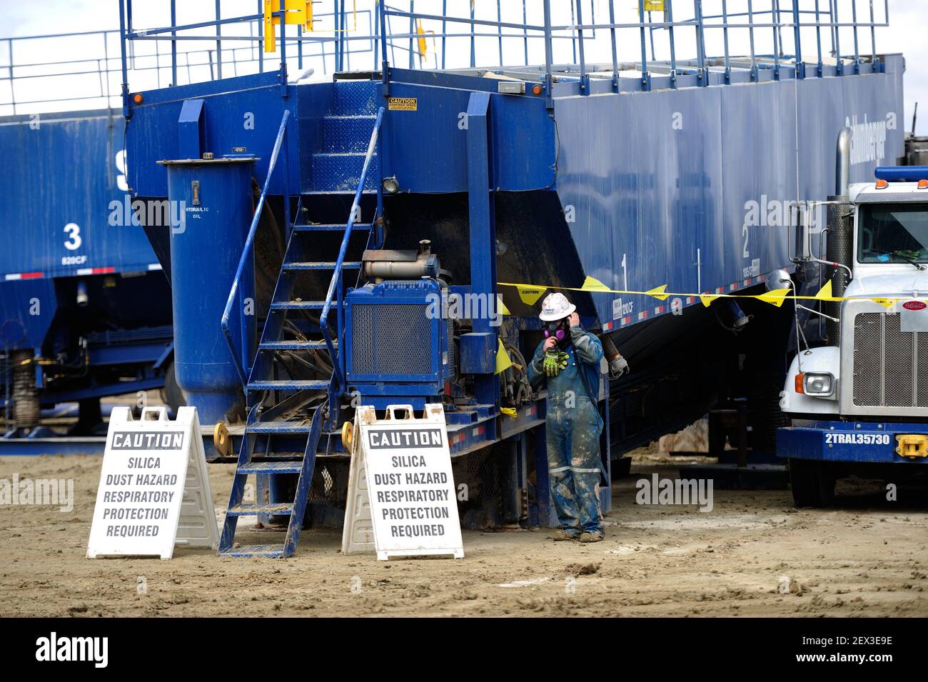 Schlumberger trucks with 2000 horsepower pumps direct water, sand and ...