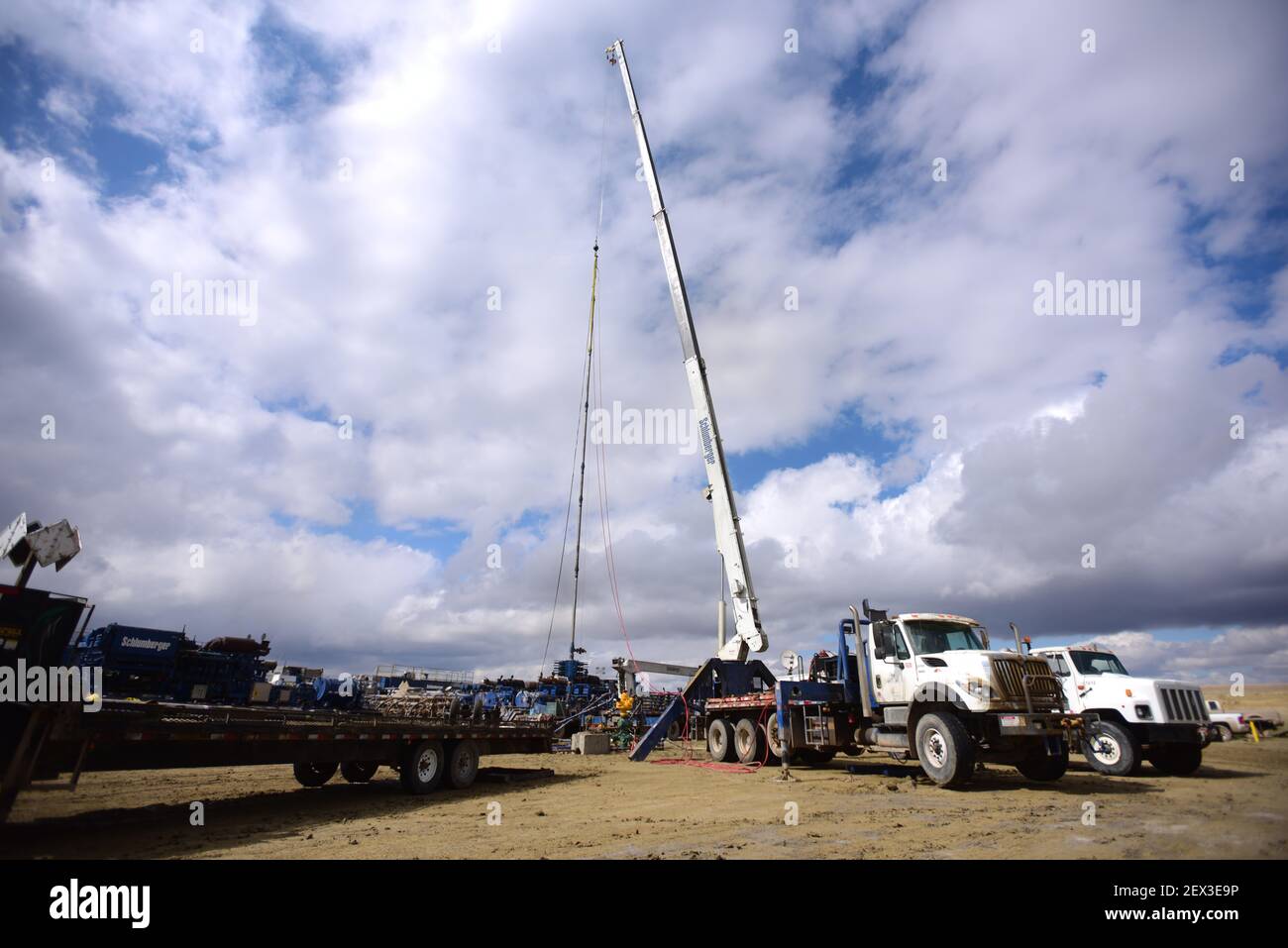 Schlumberger trucks with 2000 horsepower pumps direct water, sand and ...