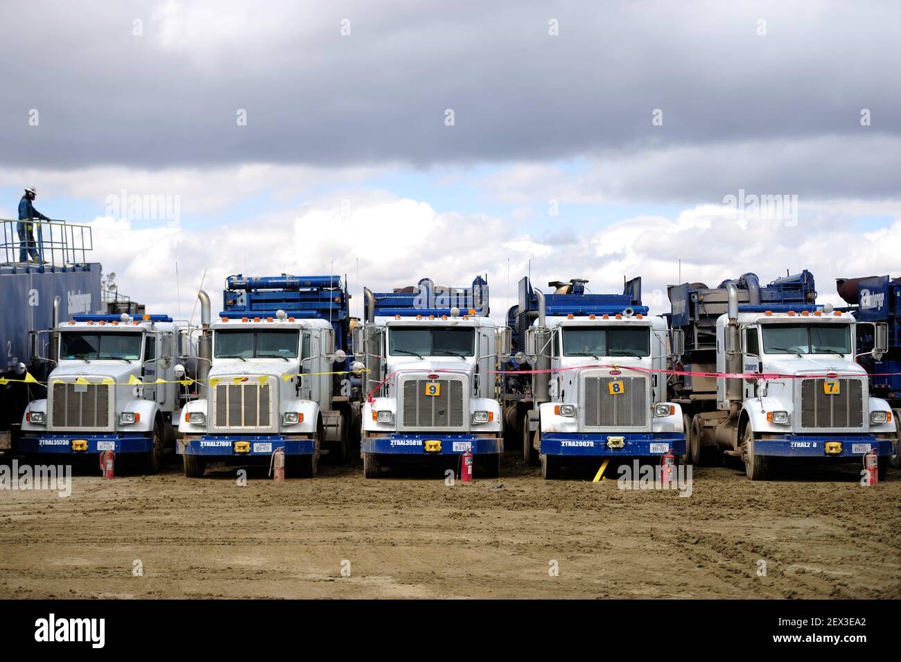 Schlumberger trucks with 2000 horsepower pumps direct water, sand and ...