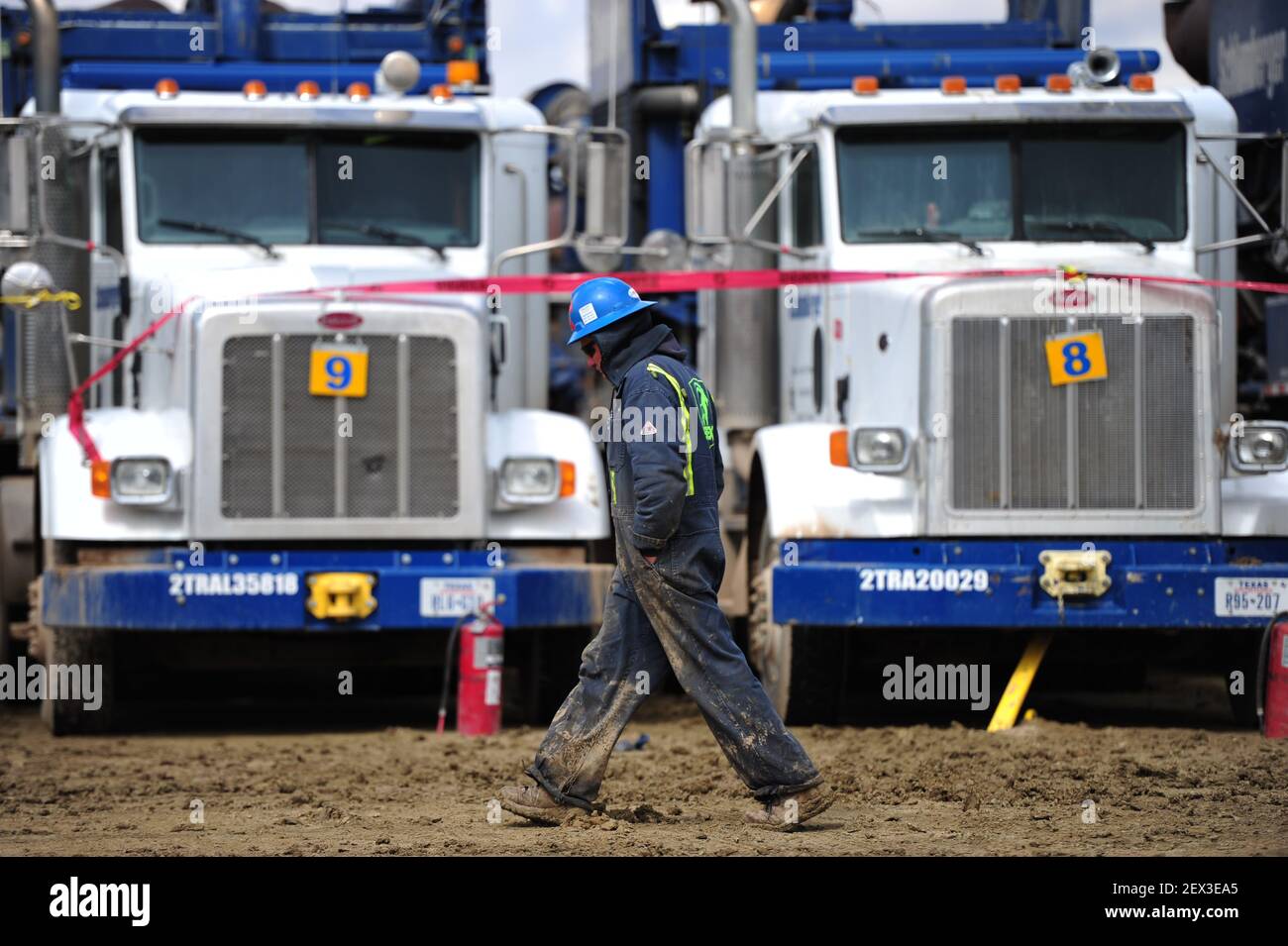 Schlumberger trucks with 2000 horsepower pumps direct water, sand and ...