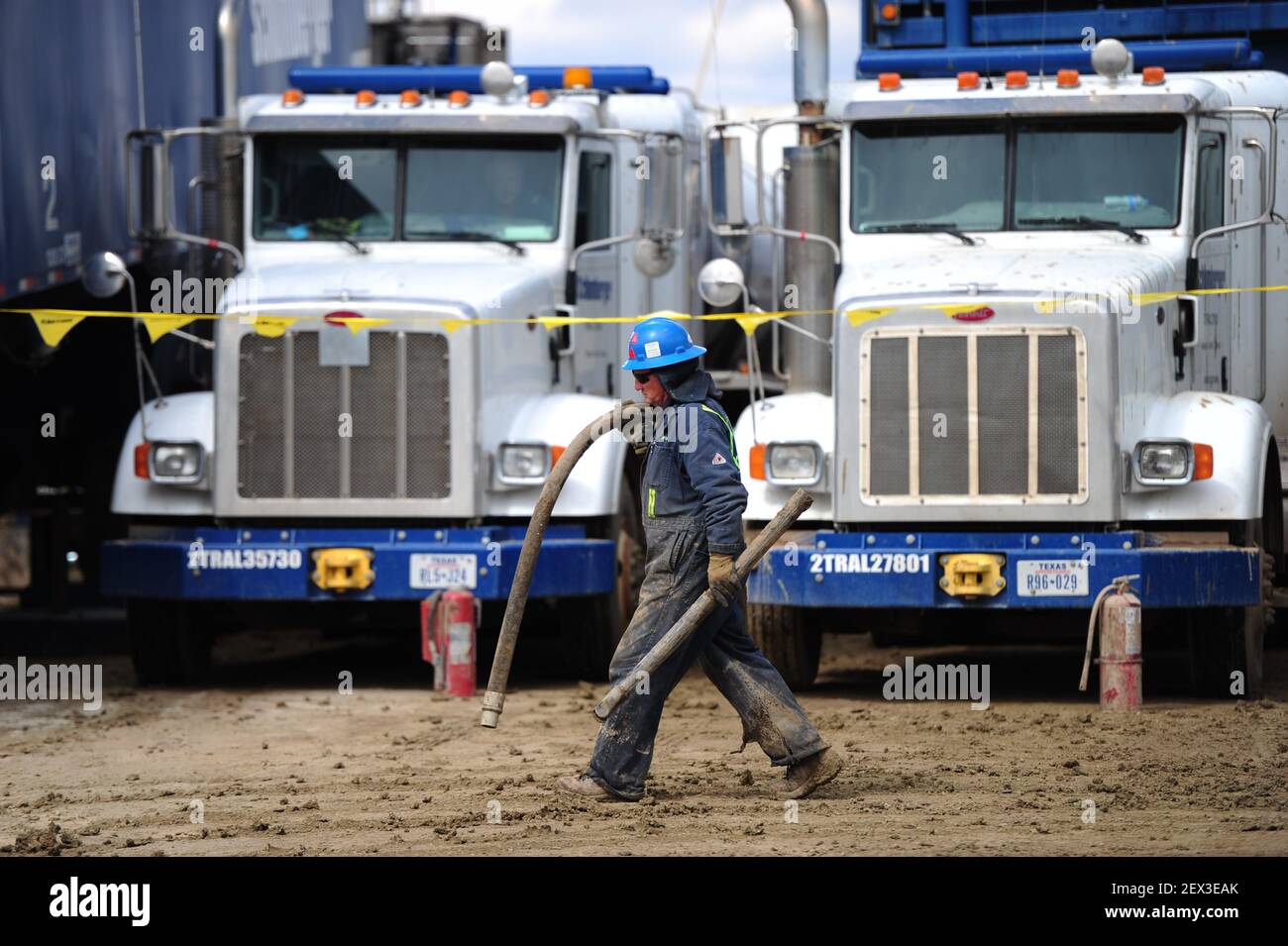 Schlumberger trucks with 2000 horsepower pumps direct water, sand and ...
