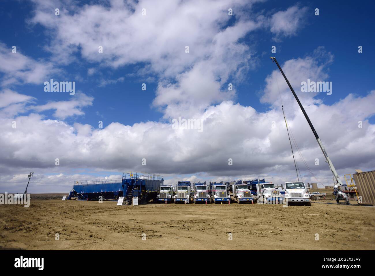 Schlumberger trucks with 2000 horsepower pumps direct water, sand and ...