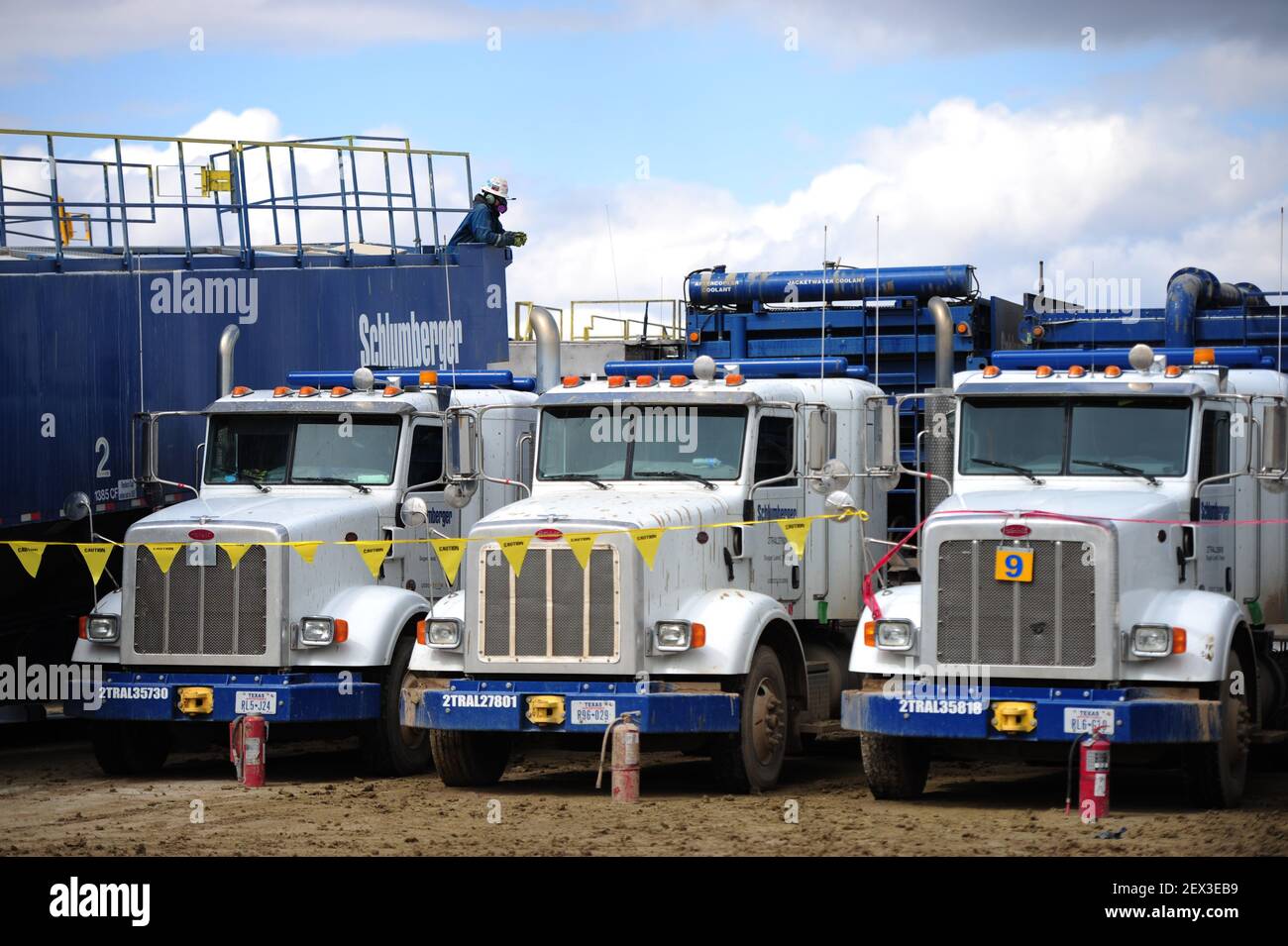 Schlumberger trucks with 2000 horsepower pumps direct water, sand and ...