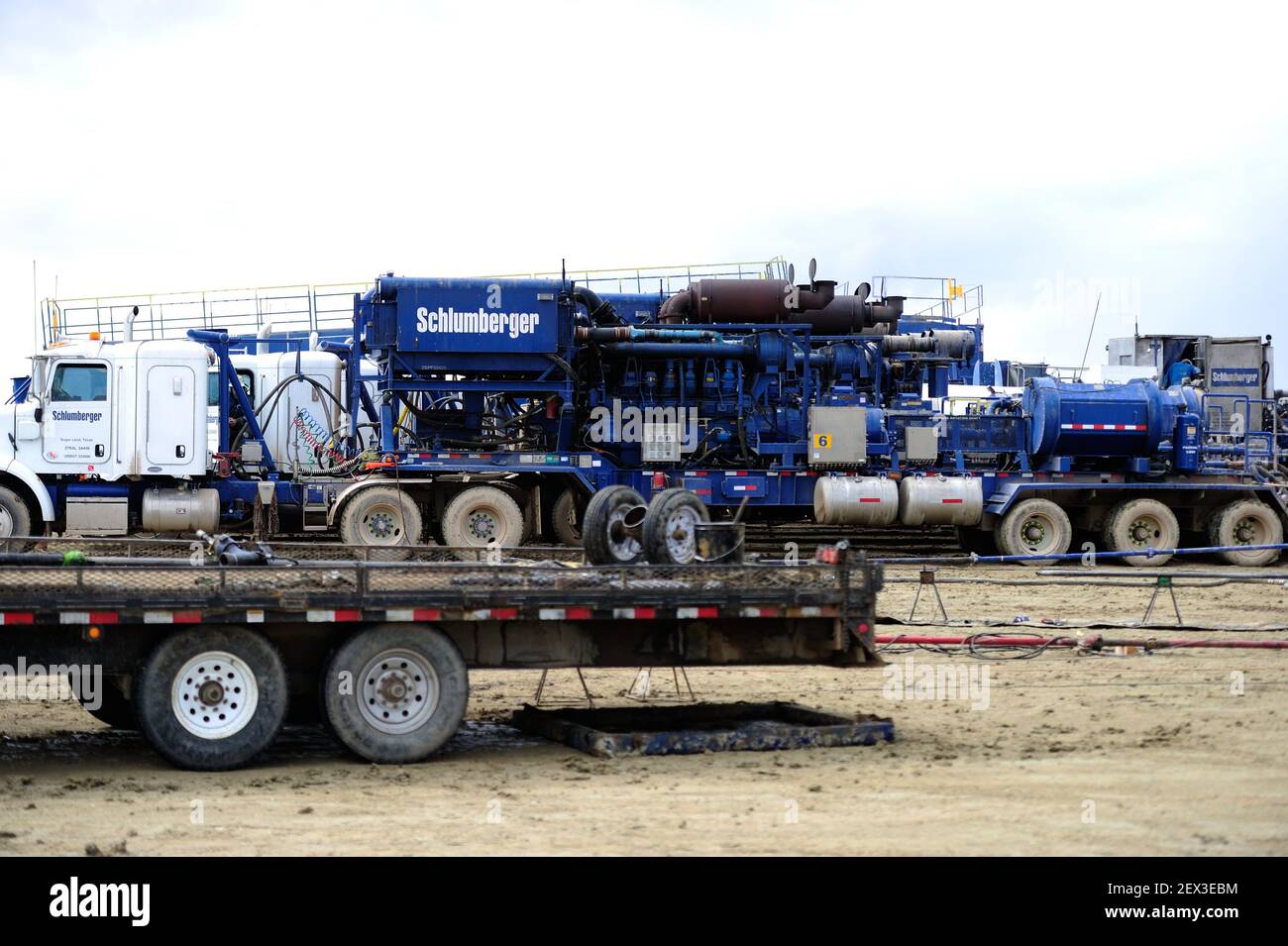 Schlumberger trucks with 2000 horsepower pumps direct water, sand and ...