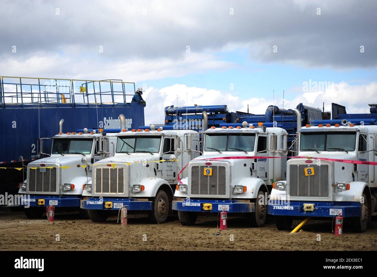 Schlumberger trucks with 2000 horsepower pumps direct water, sand and ...