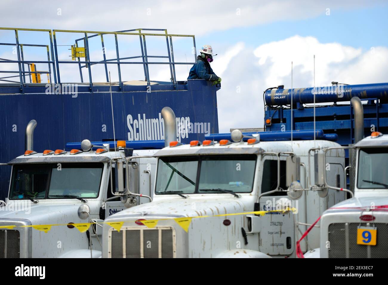 Schlumberger trucks with 2000 horsepower pumps direct water, sand and ...