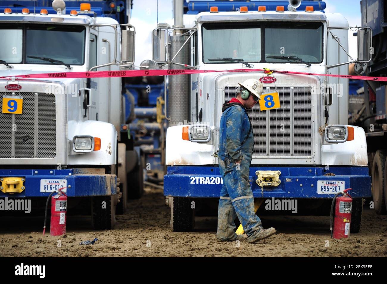 Schlumberger trucks with 2000 horsepower pumps direct water, sand and ...