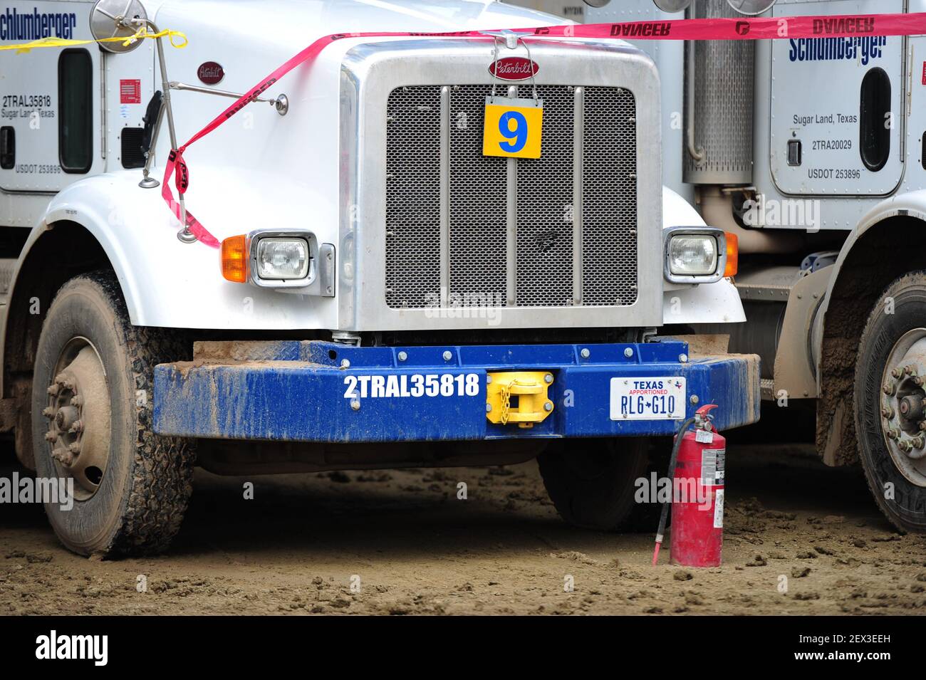 Schlumberger trucks with 2000 horsepower pumps direct water, sand and ...