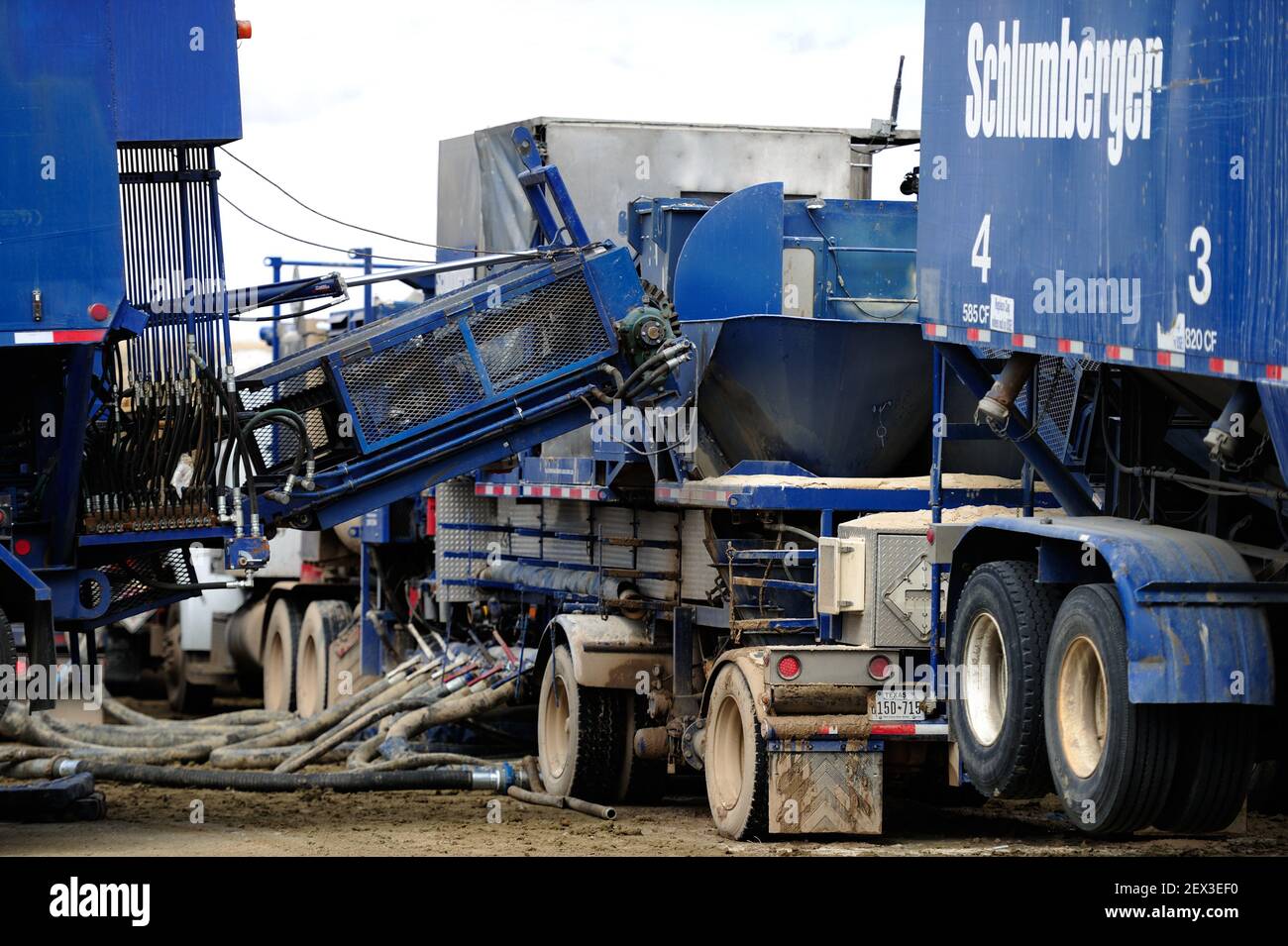 Schlumberger trucks with 2000 horsepower pumps direct water, sand and ...