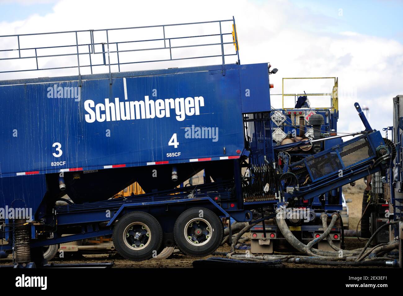 Schlumberger trucks with 2000 horsepower pumps direct water, sand and ...