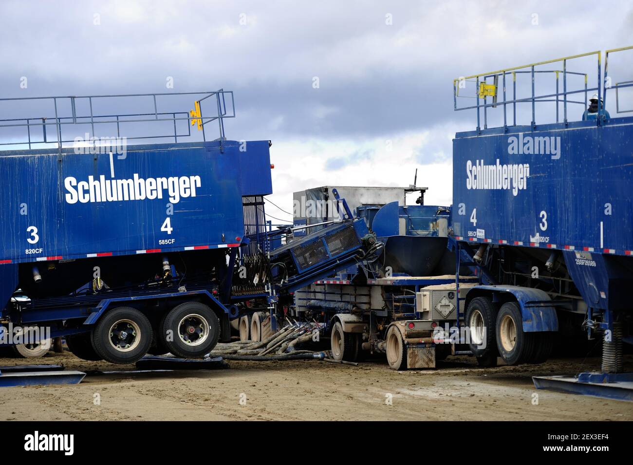 Schlumberger trucks with 2000 horsepower pumps direct water, sand and ...