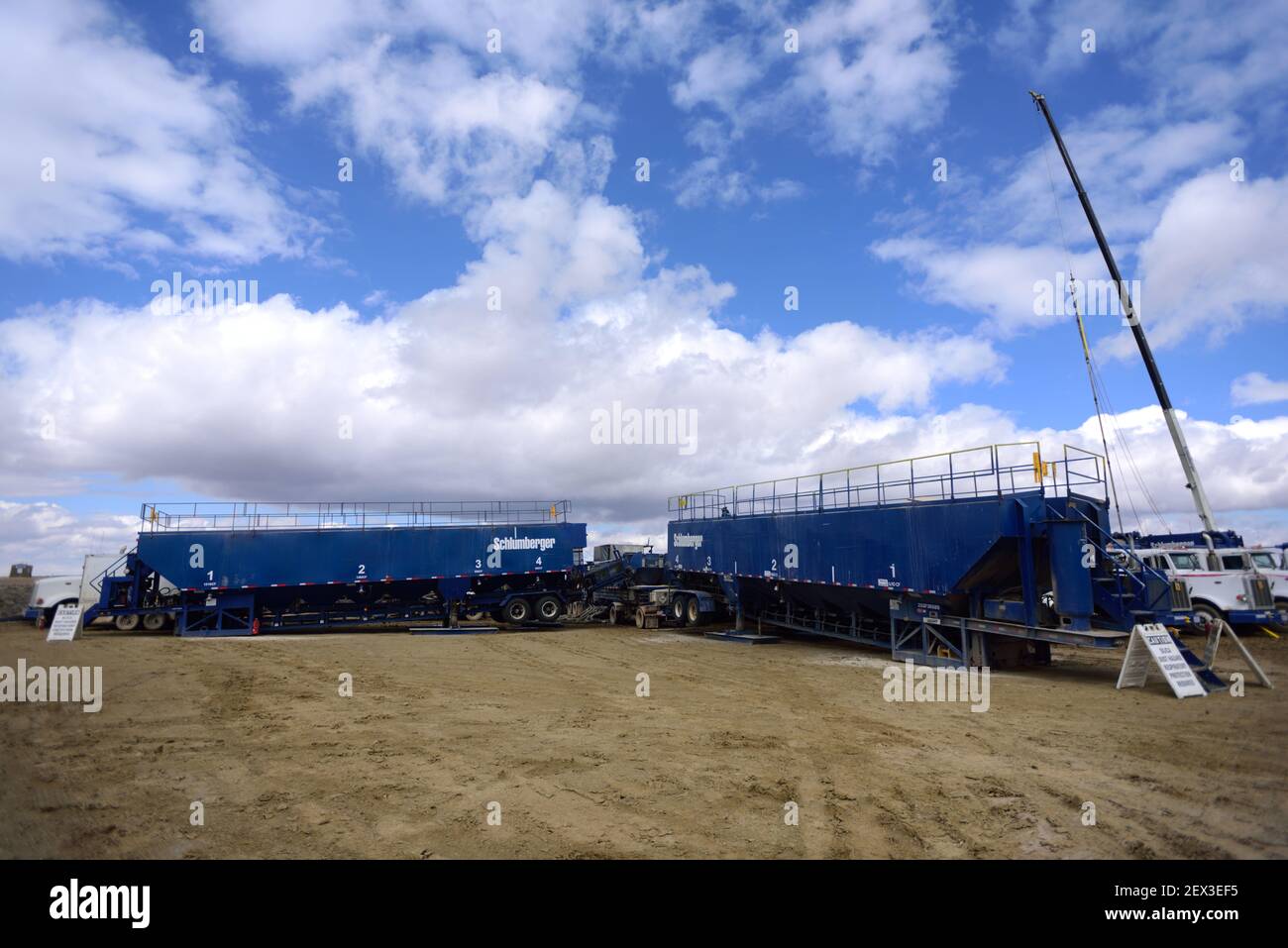 Schlumberger trucks with 2000 horsepower pumps direct water, sand and ...