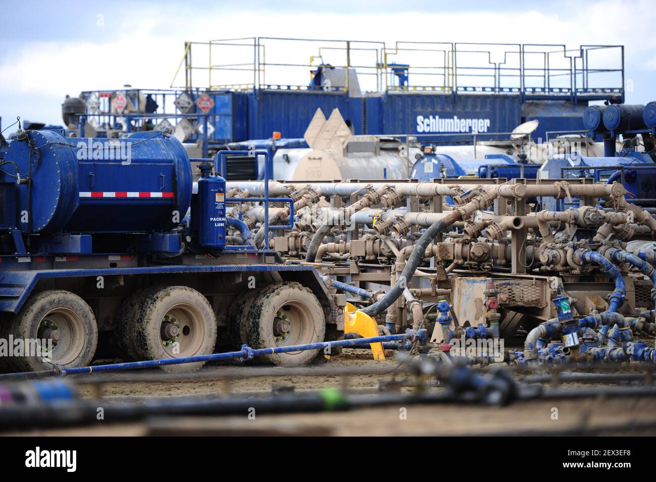 Schlumberger trucks with 2000 horsepower pumps direct water, sand and ...