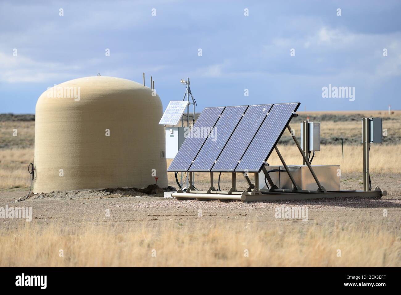 A covered wellhead with solar powered monitoring equipment pictured on ...