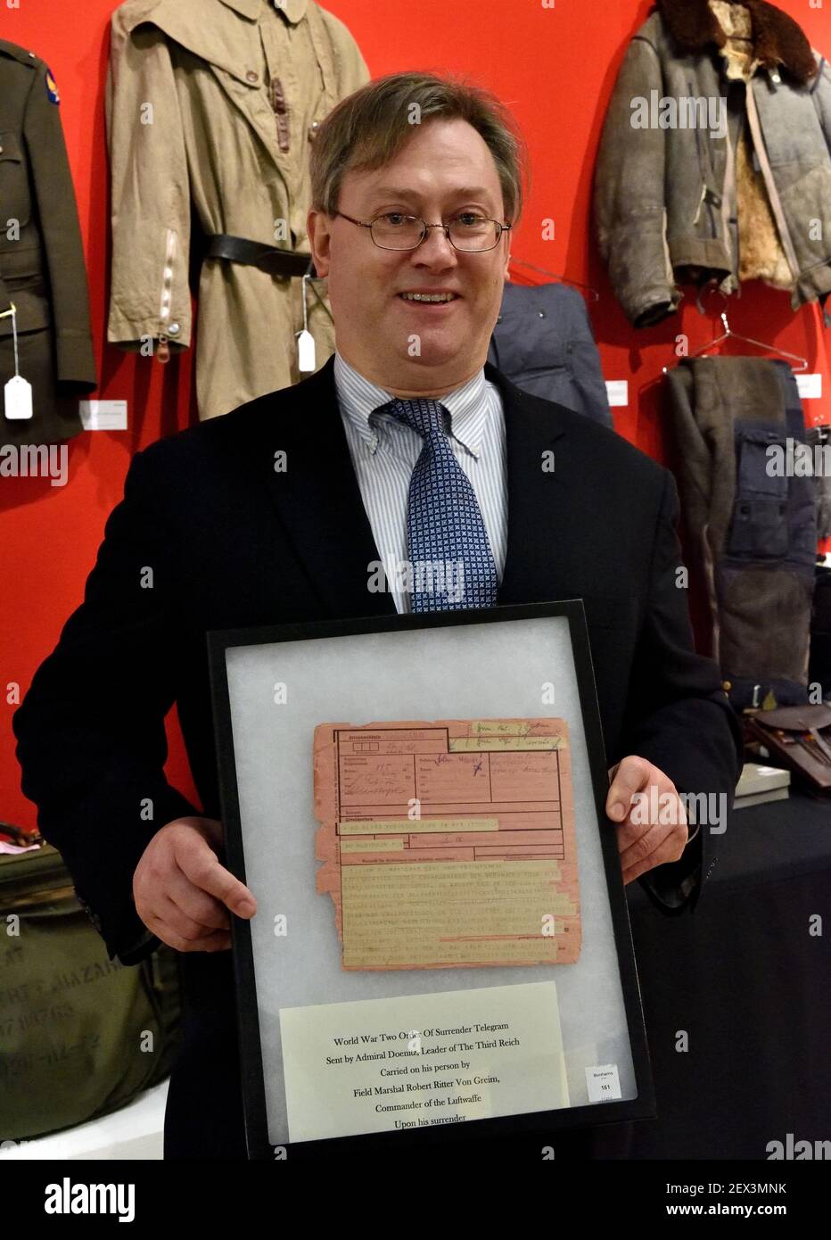 Tom Lamb, Bonhams curator, holds the Order of Surrender telegram sent ...