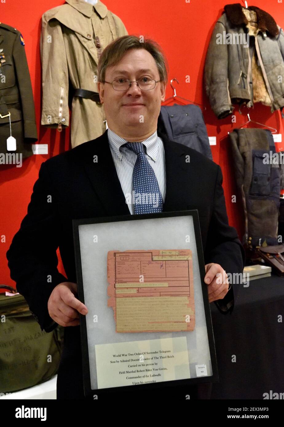 Tom Lamb, Bonhams curator, holds the Order of Surrender telegram sent ...