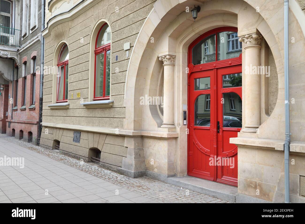 Beautiful residential architecture in Wroclaw, Poland. Old red wooden door to an apartment ...