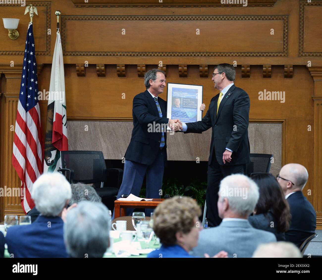 Secretary of Defense Ash Carter receives a poster from Dr. David Relman ...