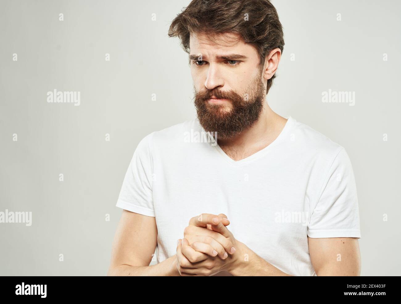 Man in t-shirt cropped view model sad face emotions Stock Photo - Alamy