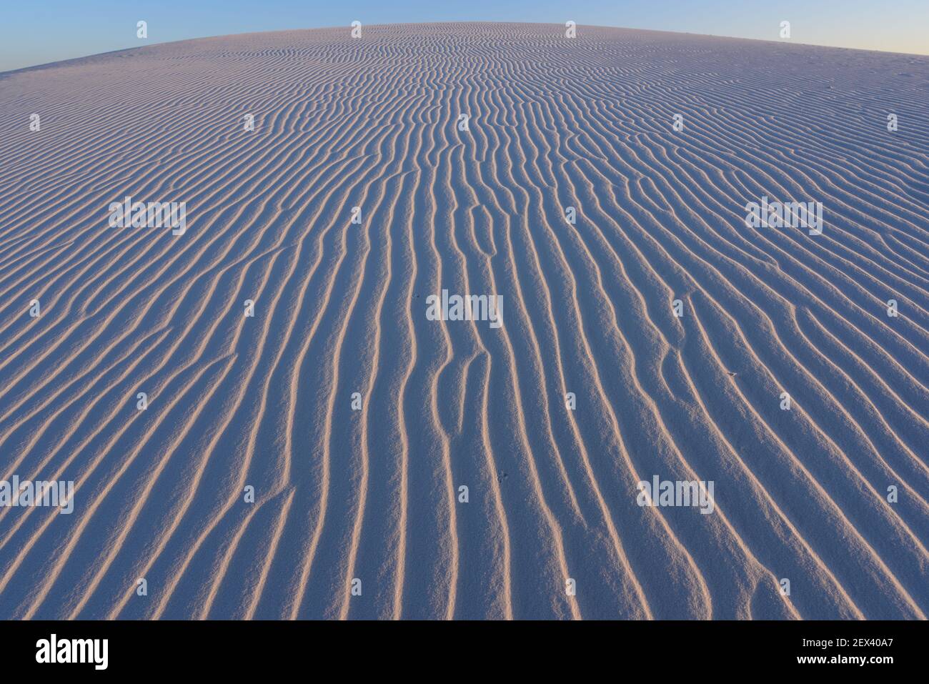 The sun rises over the gypsum dunes at White Sands National Monument ...