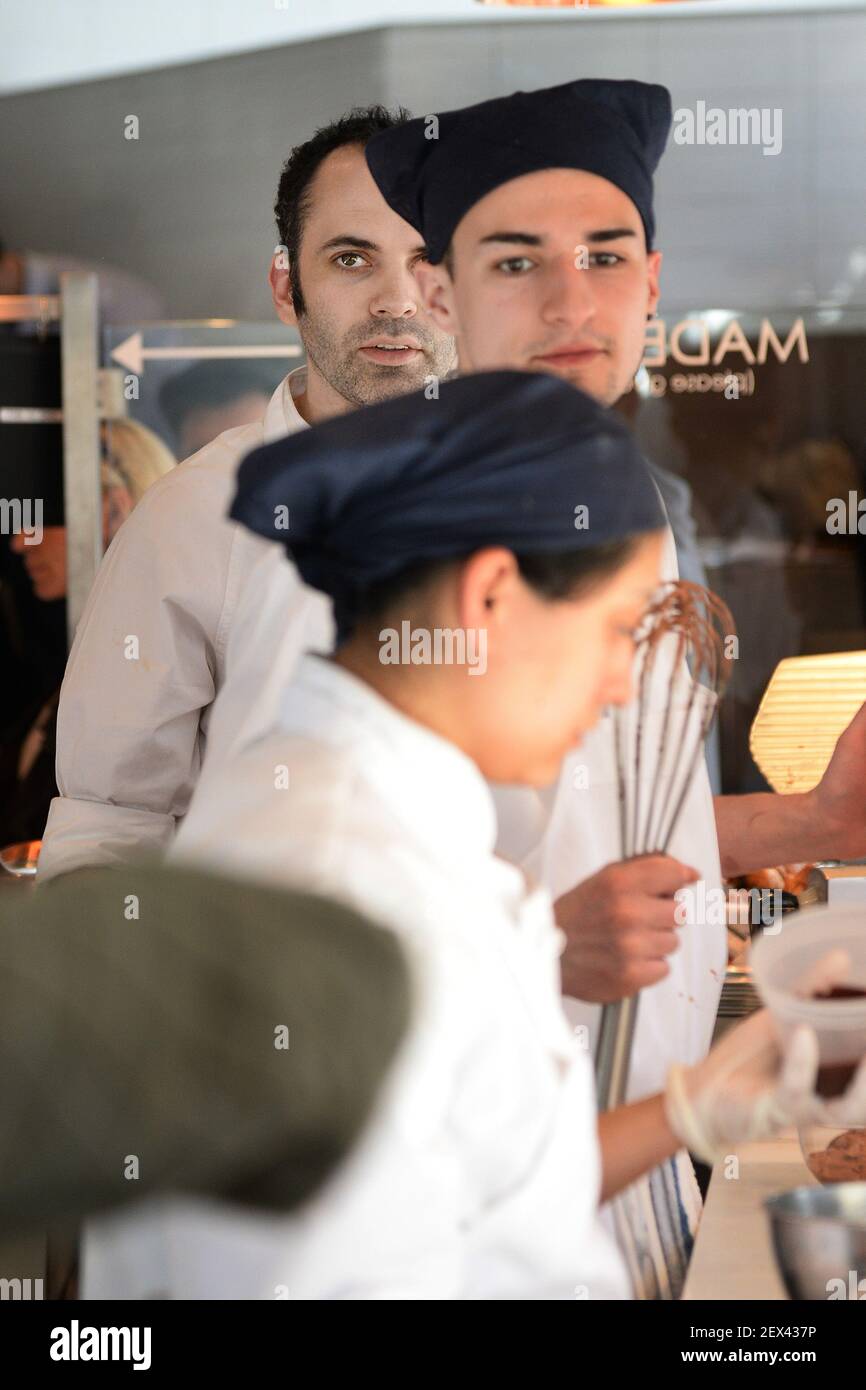 Chef Dominique Ansel (without hat) helps prepare customer orders on ...