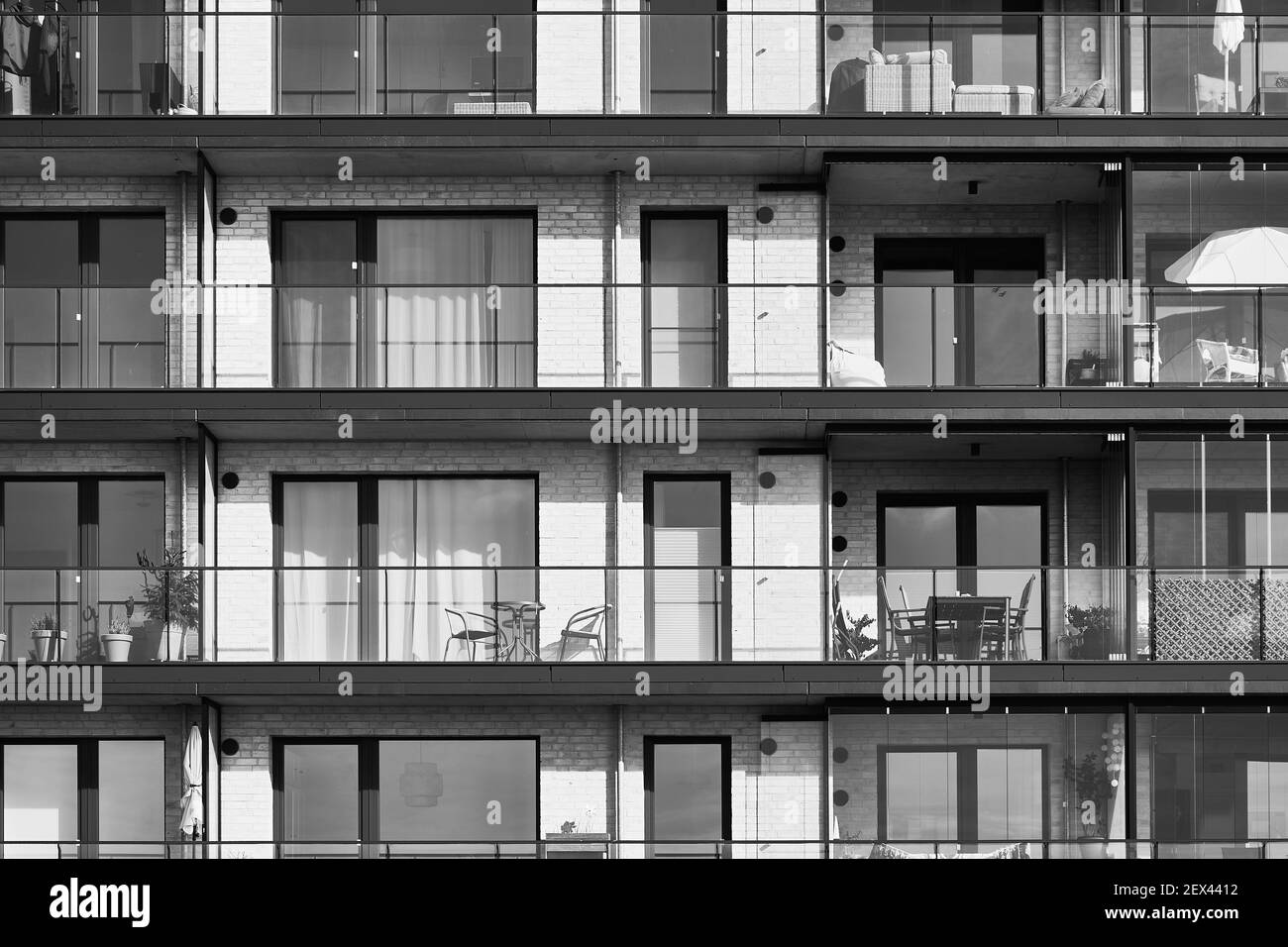 Monotonous balconies and terraces with tables and chairs in a big ...