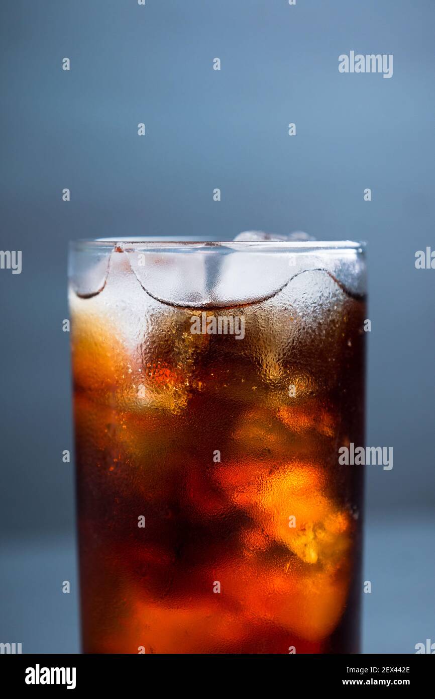 Cold cola beverage in glass with ice. Selective focus. Shallow depth of ...