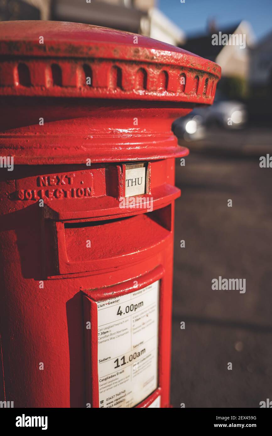 SWANSEA, UK - FEBRUARY 25, 2021: Classic vintage red British pillar box ...