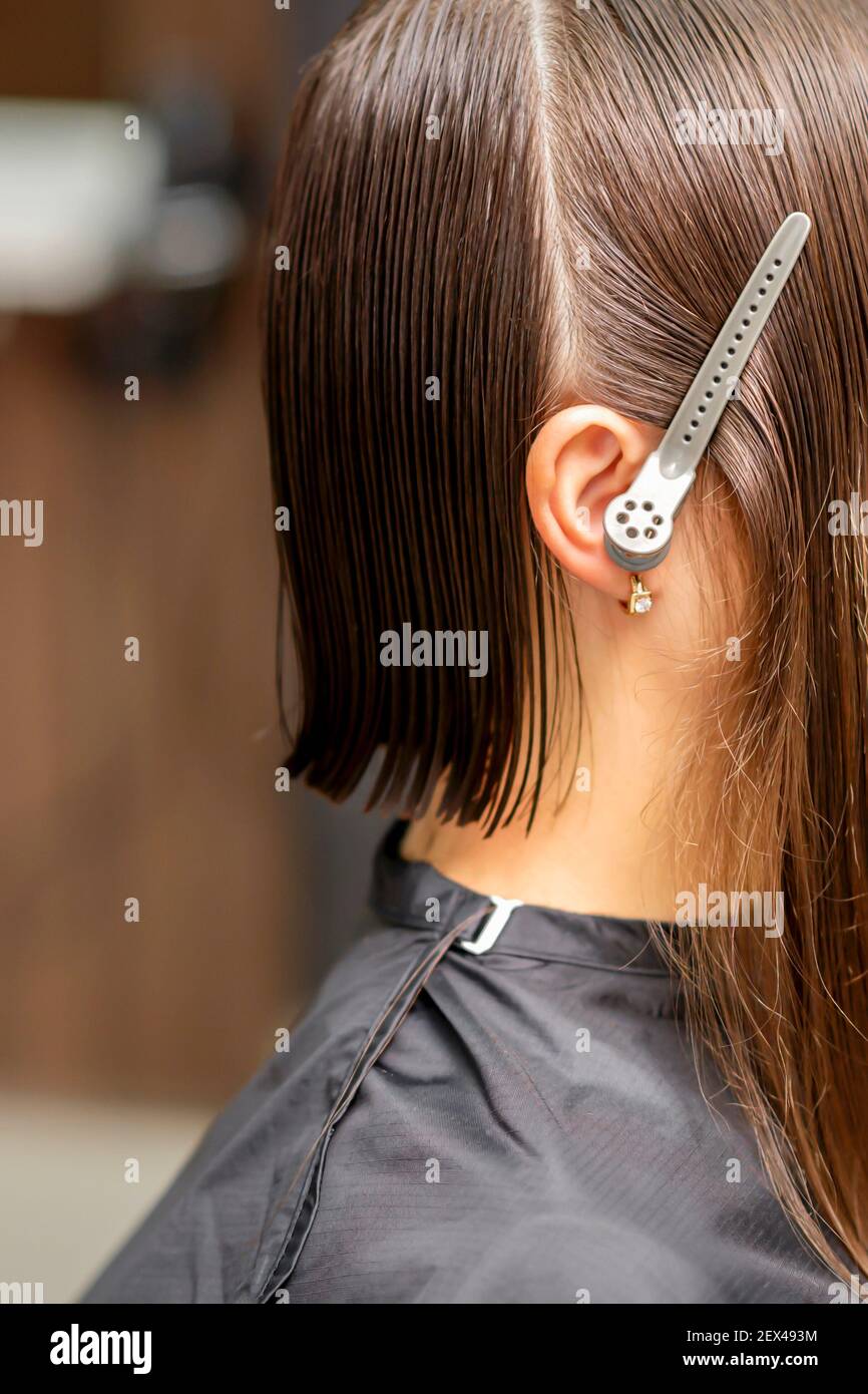 Close up side view of young brunette caucasian woman with split hair in ...