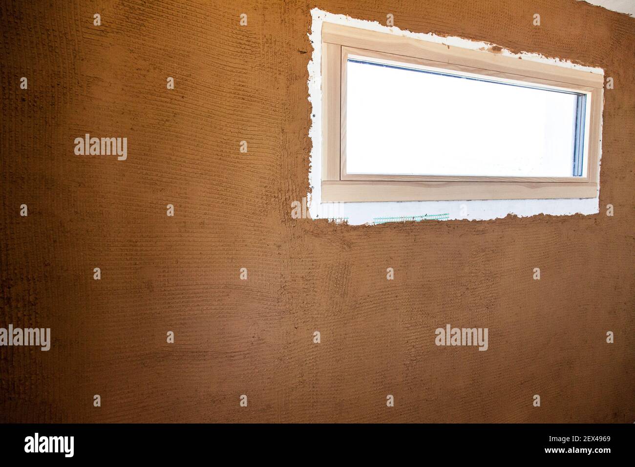 Application of a raw earth coating on a wall, France Stock Photo - Alamy