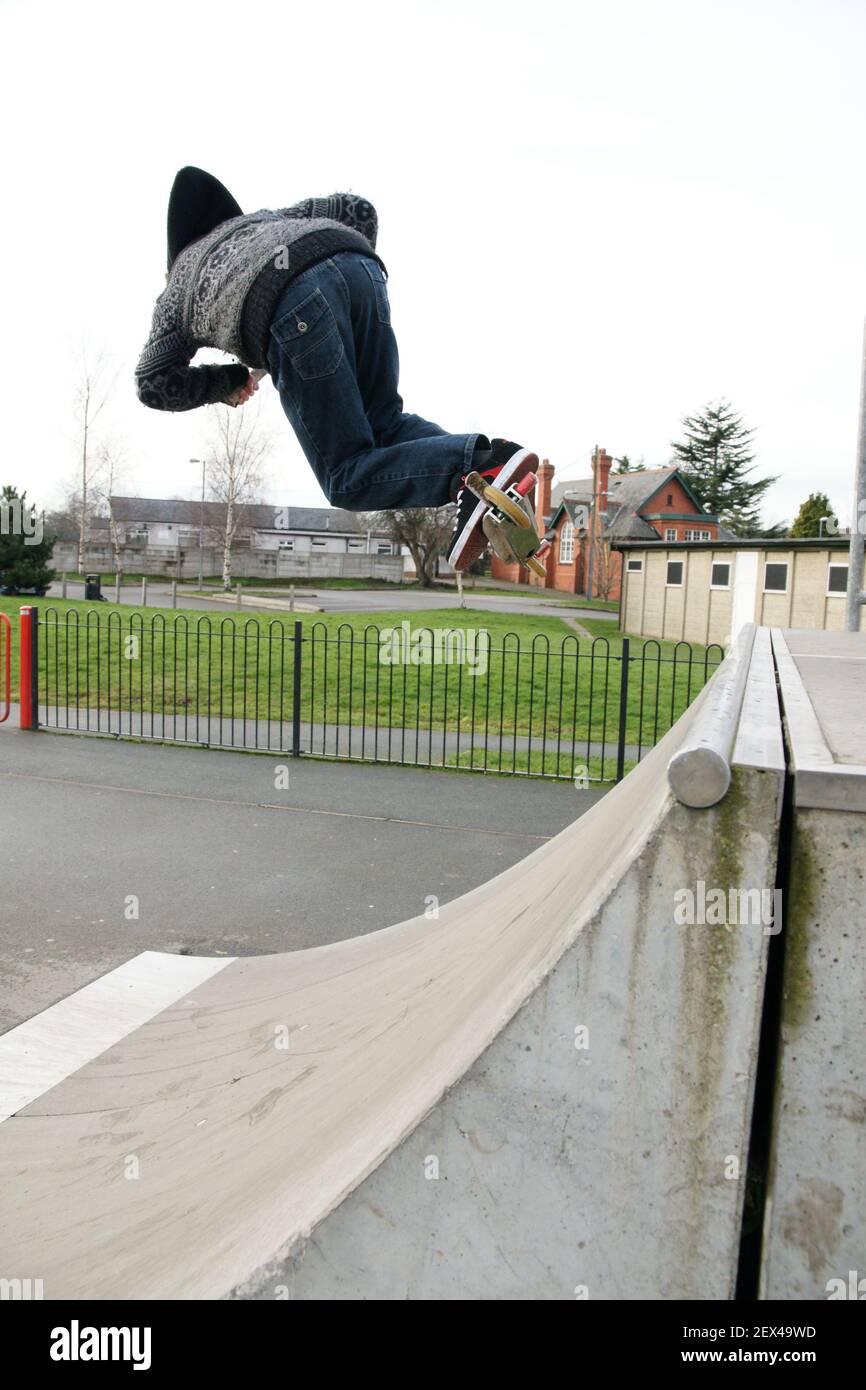 A view of teenager jumping a ramp with scooter used for stunt riding at ...