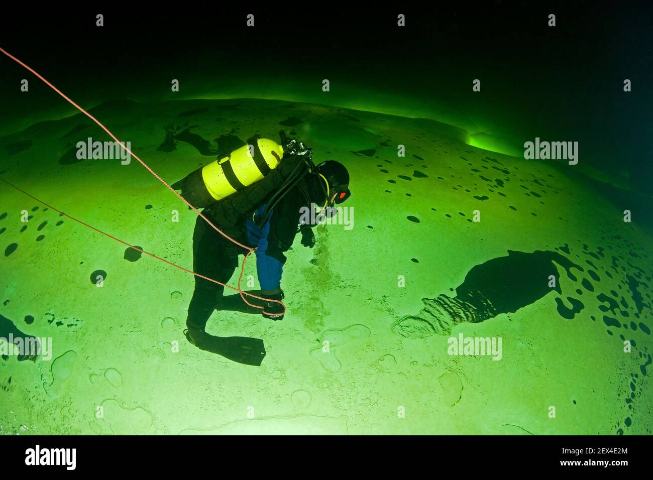 Scuba diver under ice walking upside down, exercise to practice ...