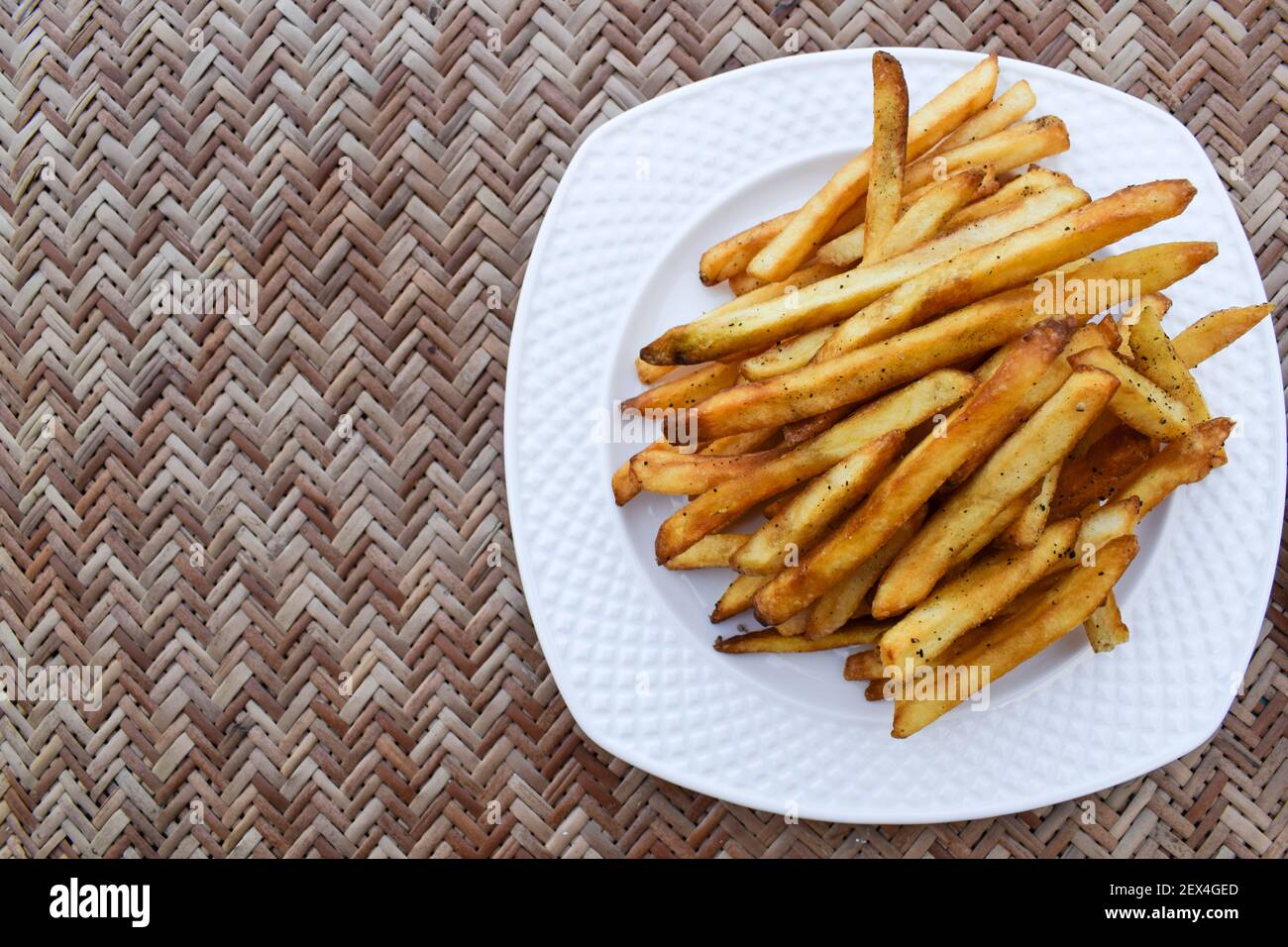 Crispy crunchy French fries heap. Potato finger chips with seasoning ...