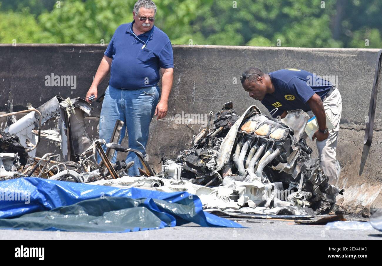 NTSB Safety Investigator Eric Alleyne, right, and other officials ...
