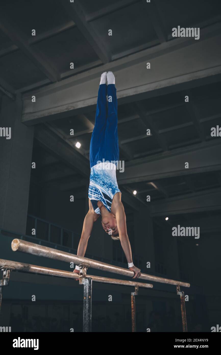 Energy. Little male gymnast training in gym, composed and active ...