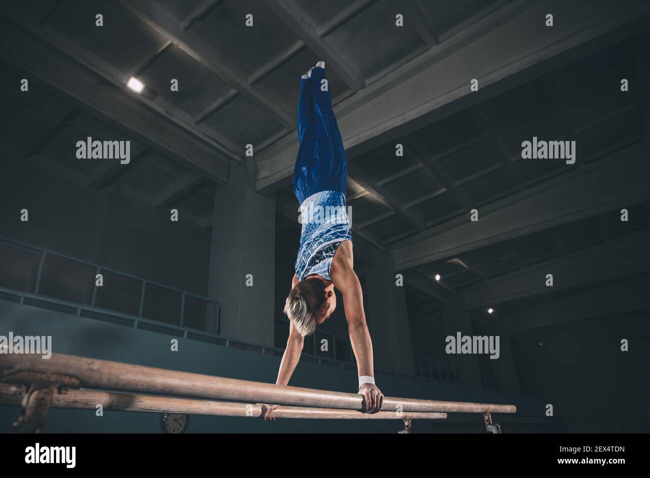 Skillful. Little male gymnast training in gym, composed and active ...