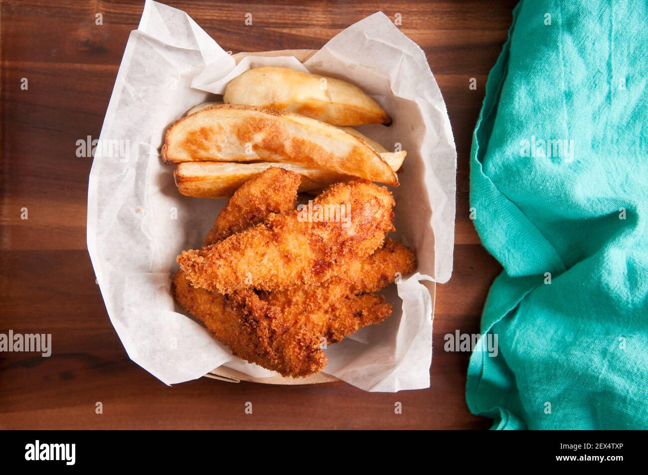 breaded chicken fingers and fries in a take out container Stock Photo ...