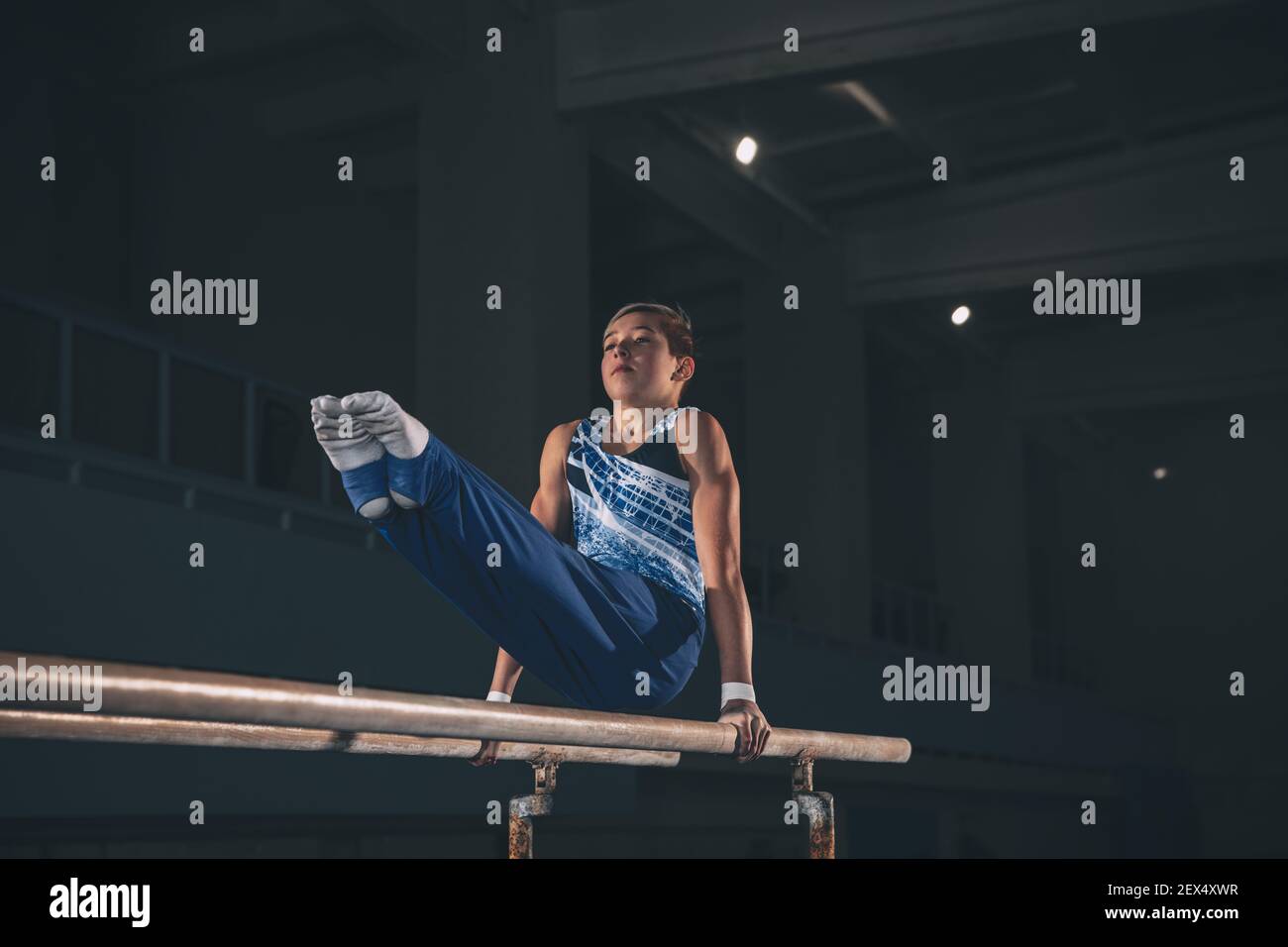 Experience. Little male gymnast training in gym, composed and active ...