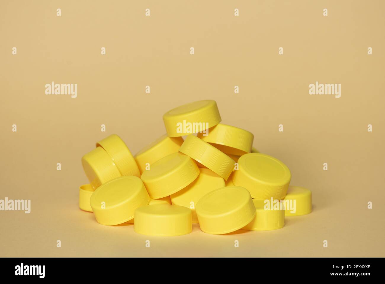 A closeup shot of a stack of yellow plastic bottle caps Stock Photo - Alamy