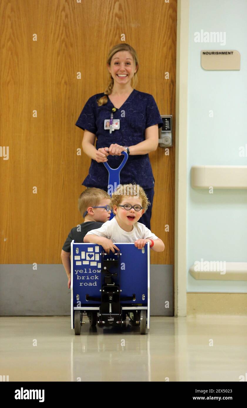 Jaxson and Easton Seeman, 3, get a ride from Stephanie Neubert, RN, on ...