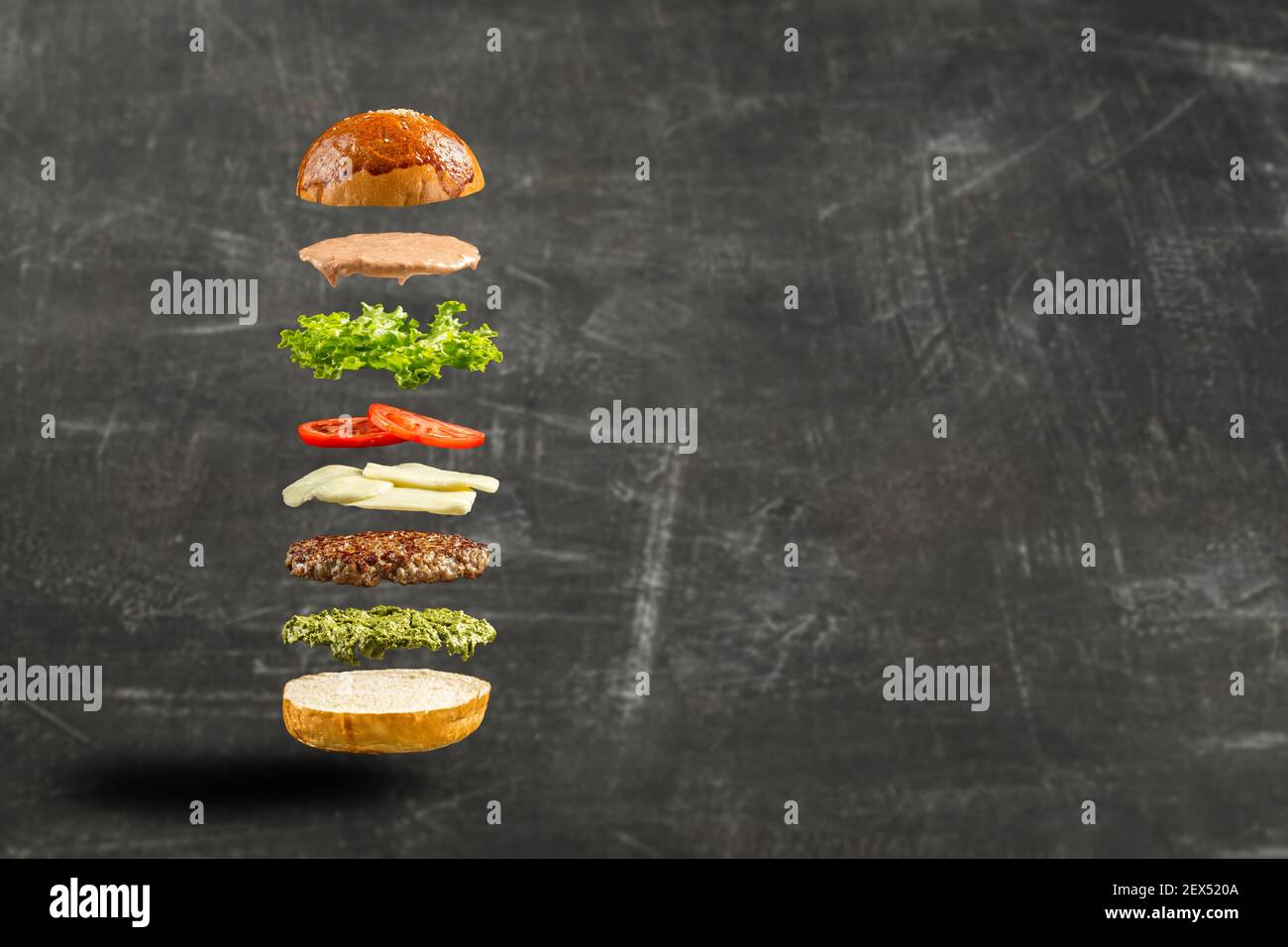 Floating burger ingredients on the grey background Stock Photo - Alamy