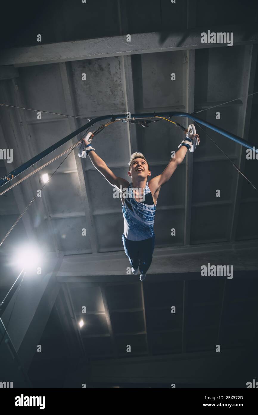 Flying. Little male gymnast training in gym, composed and active ...