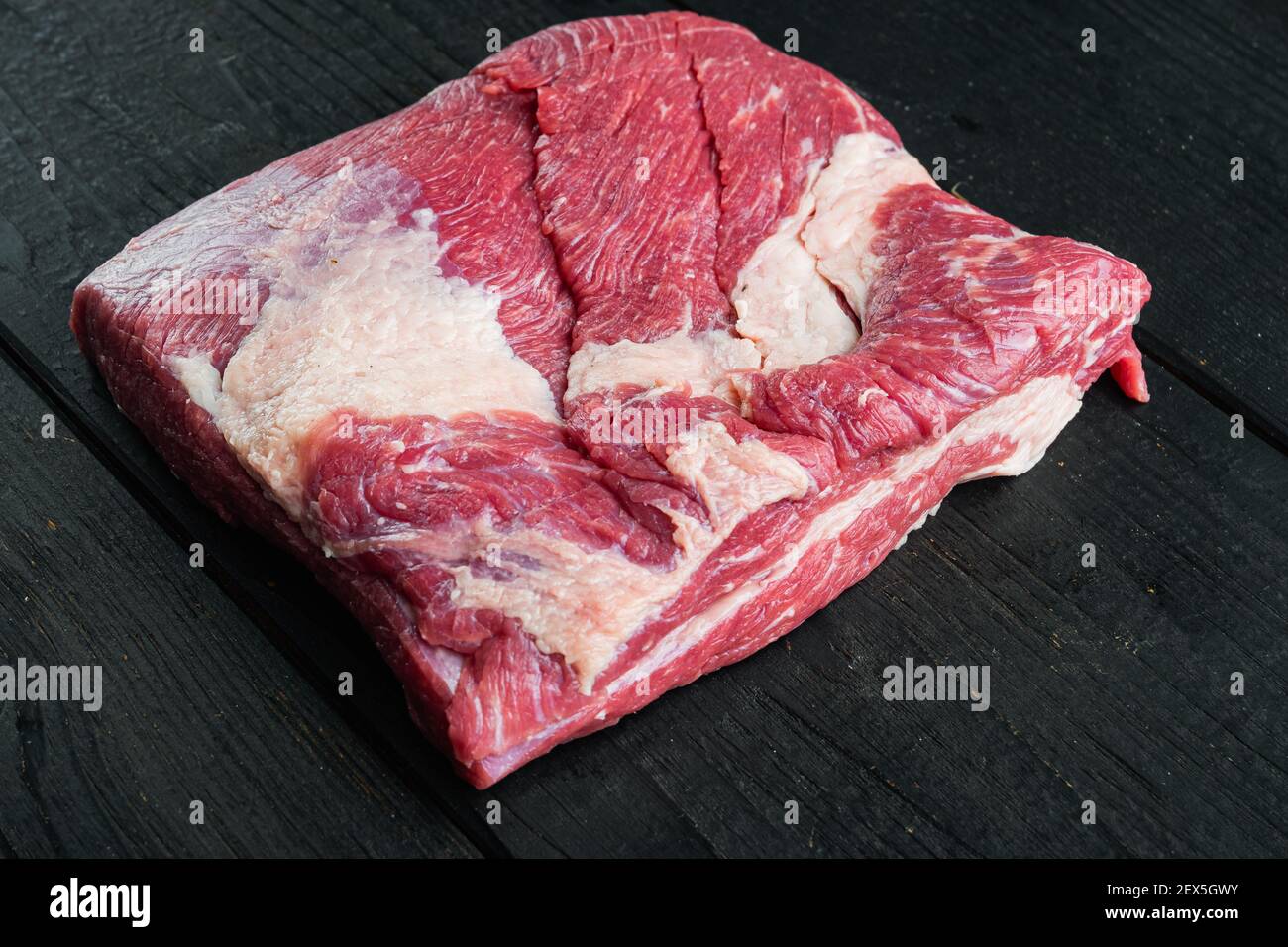 Raw brisket beef cut. Black Angus beef set, on black wooden table ...