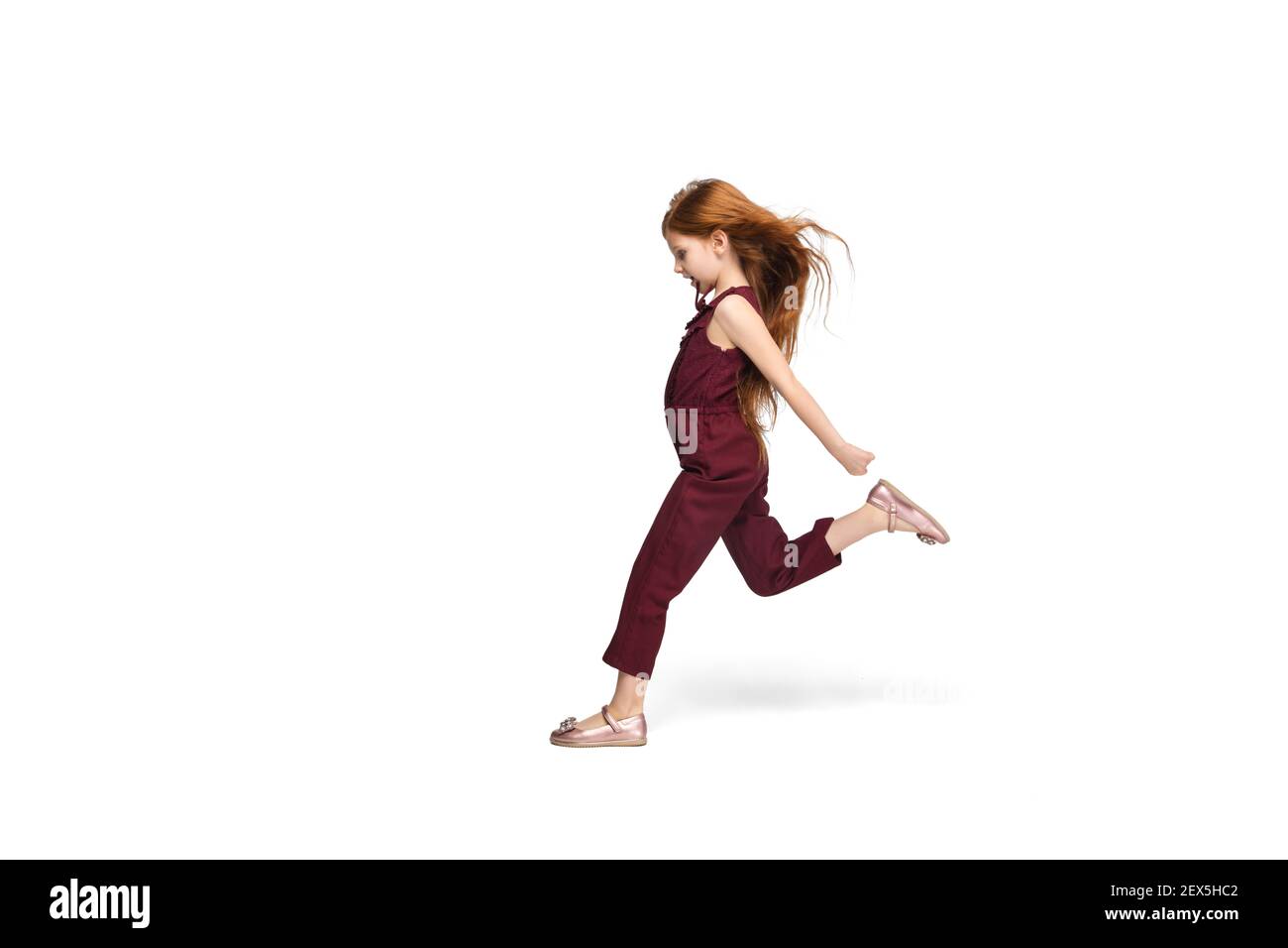 Jumping, running. Happy, smiley little caucasian girl isolated on white ...